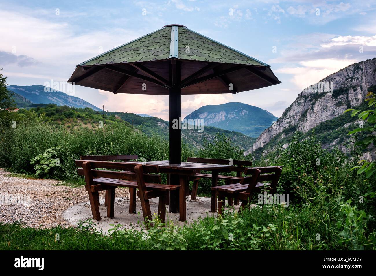 Table in the mountain resting place with a canopy from the rain and ...