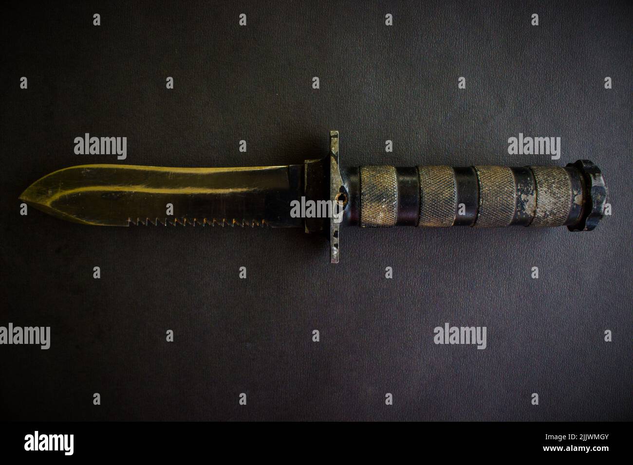 dark black military knife on black background Stock Photo - Alamy