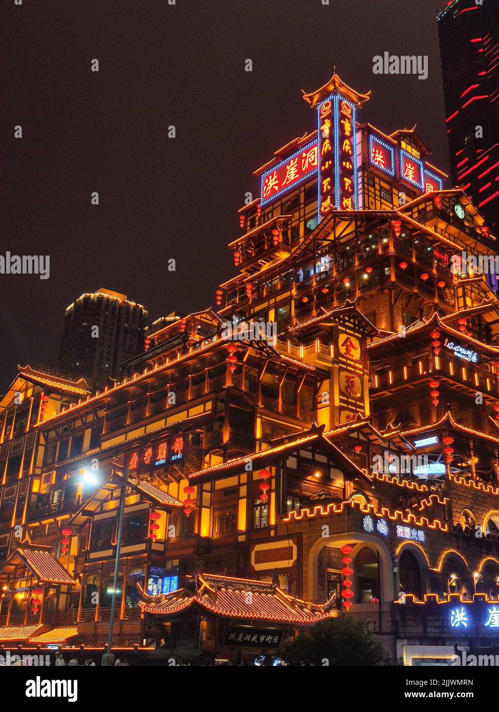 A vertical shot of illuminated buildings in Asian style during the ...