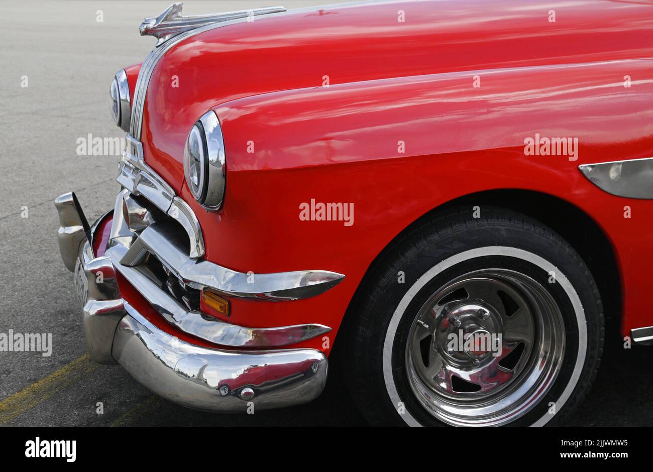 Vintage 1956 red Oldsmobile Futura with a polished chrome bumper and ...