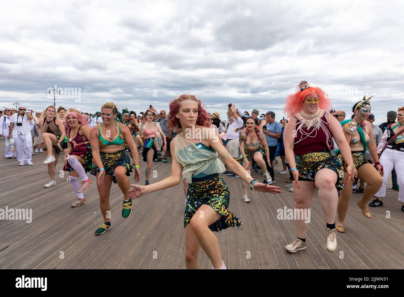 A group of people in costumes dancing at the 40th Annual Mermaid Parade ...