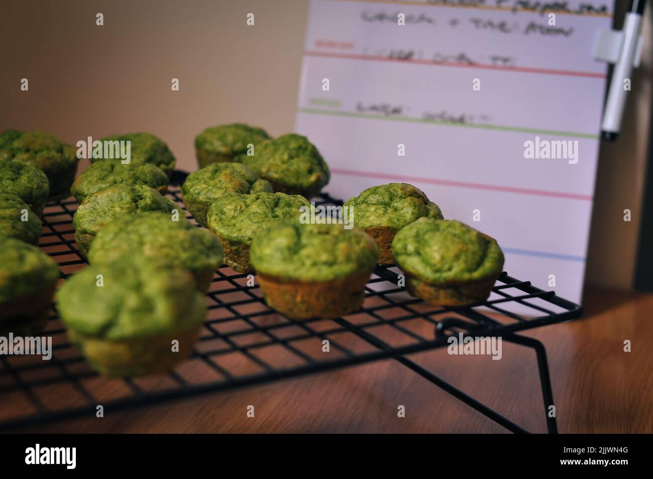 ready-made small green muffins with spinach on a baking sheet.healthy ...