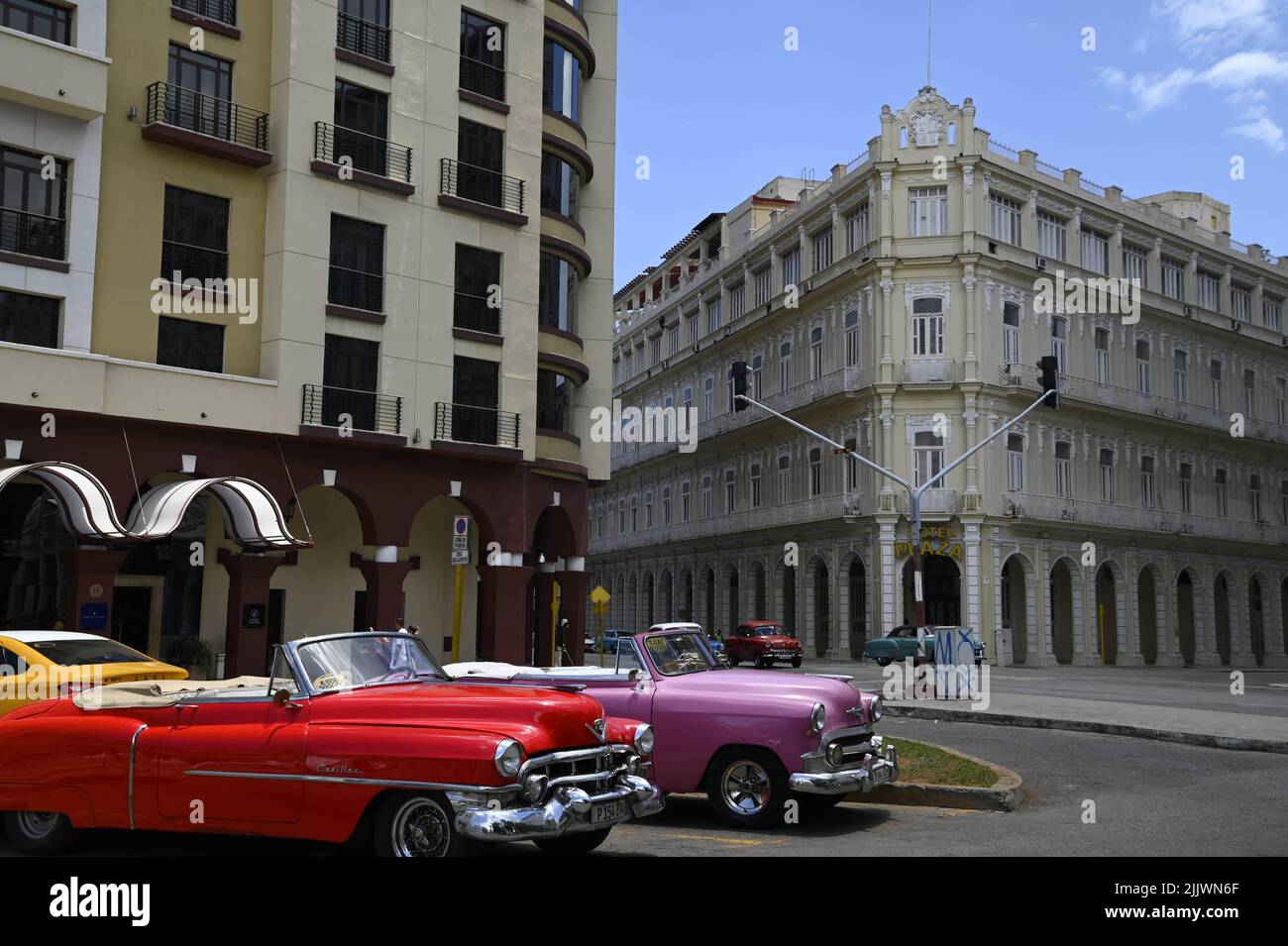 Vintage pink and red convertible Cadillac antique cars in the historic ...