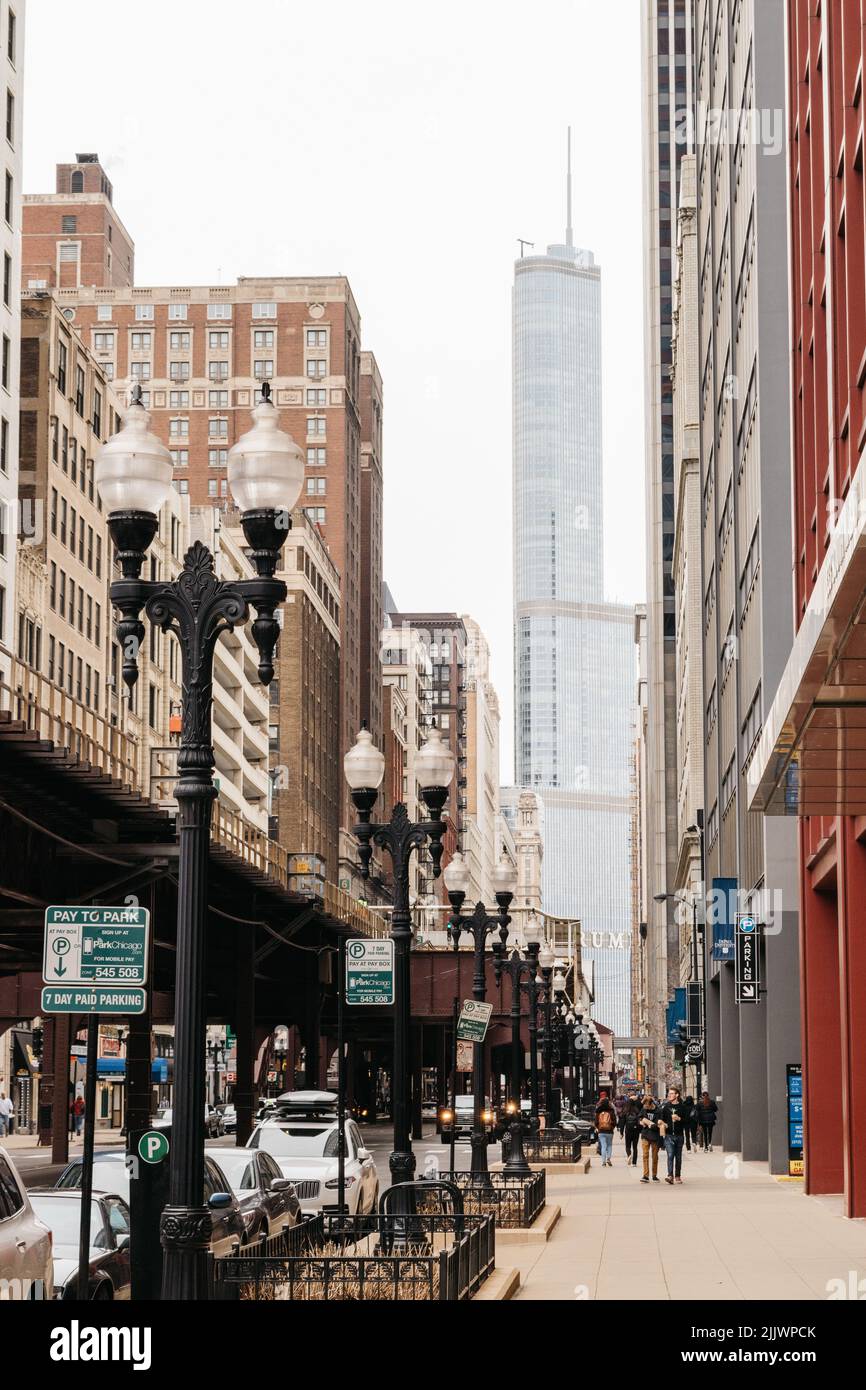 A street view in Chicago city, people walking and street lights with ...