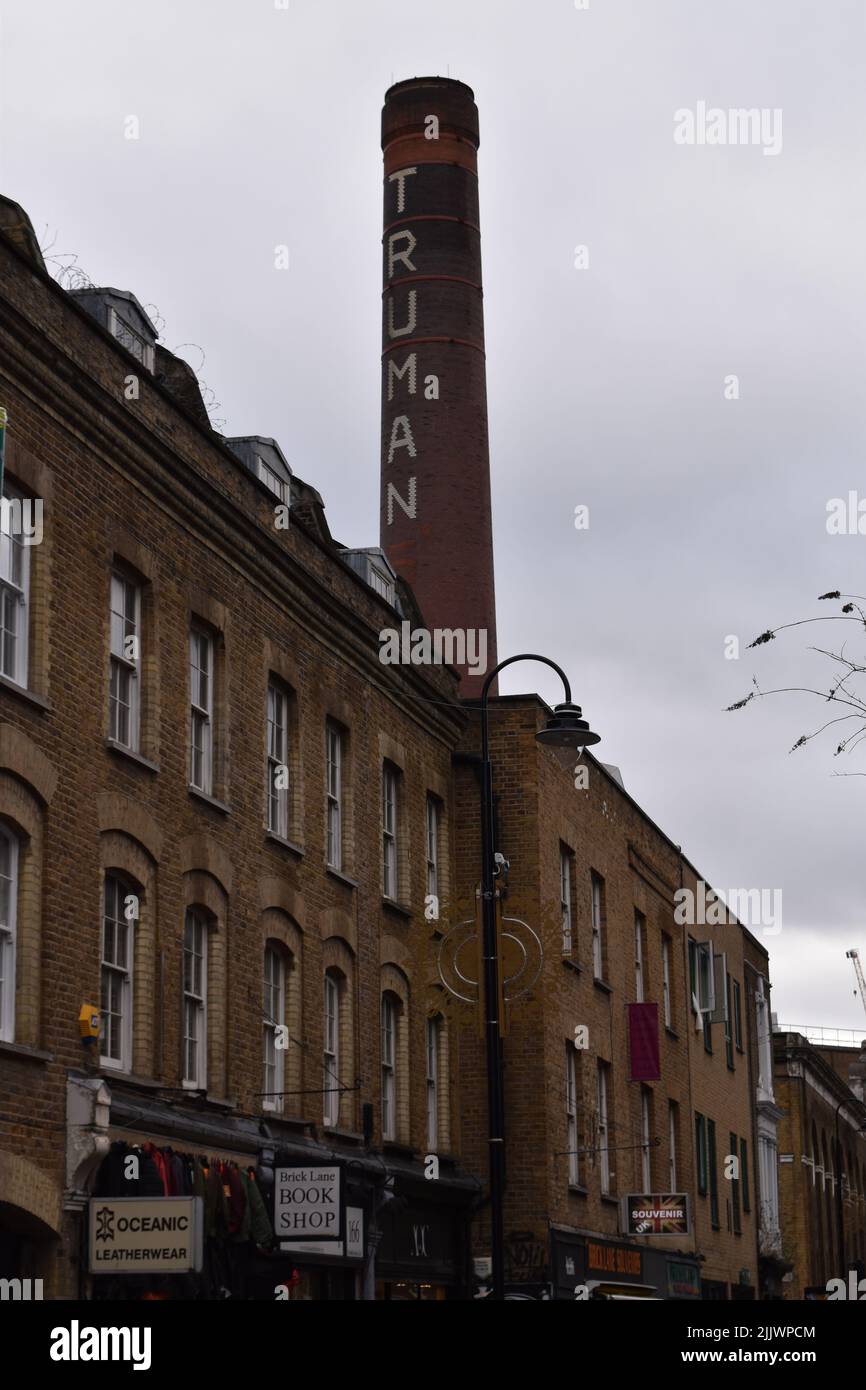 A vertical shot of a chimney on the top of building in London Truman ...