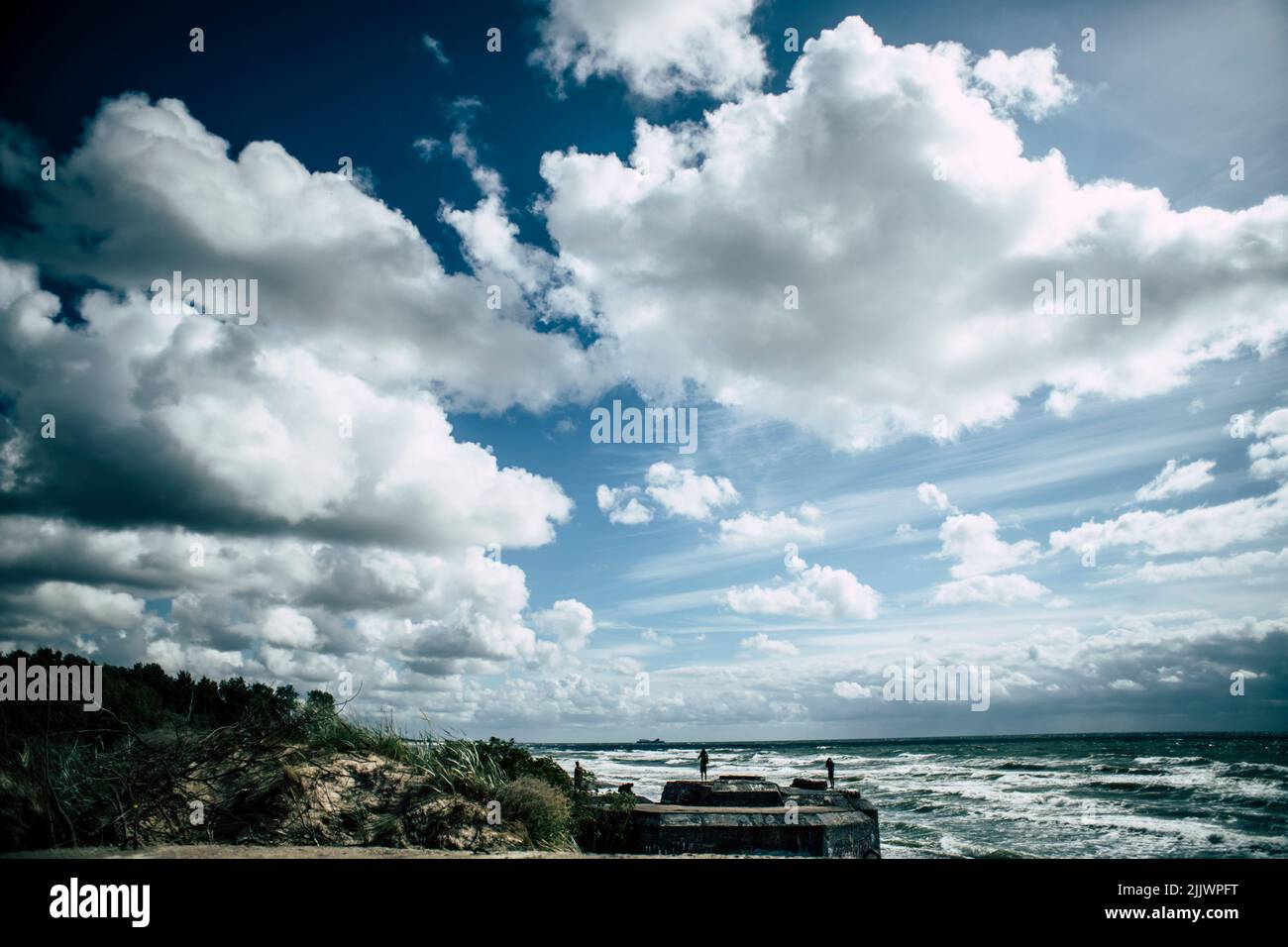 a beach view with hills and clouds running over the beach Stock Photo ...