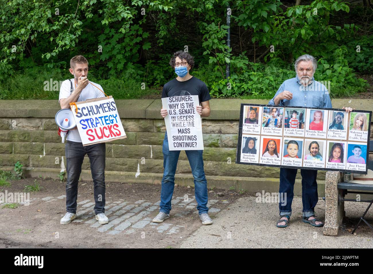 A small crowd with signs protesting for senator against gun violence ...