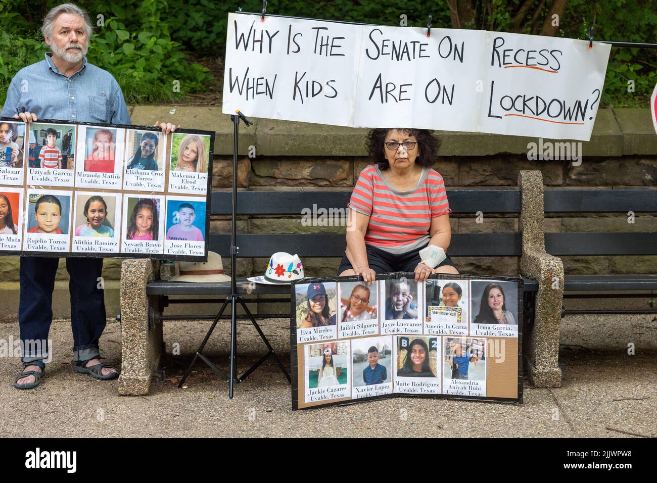 A small crowd with signs protesting for senator against gun violence ...