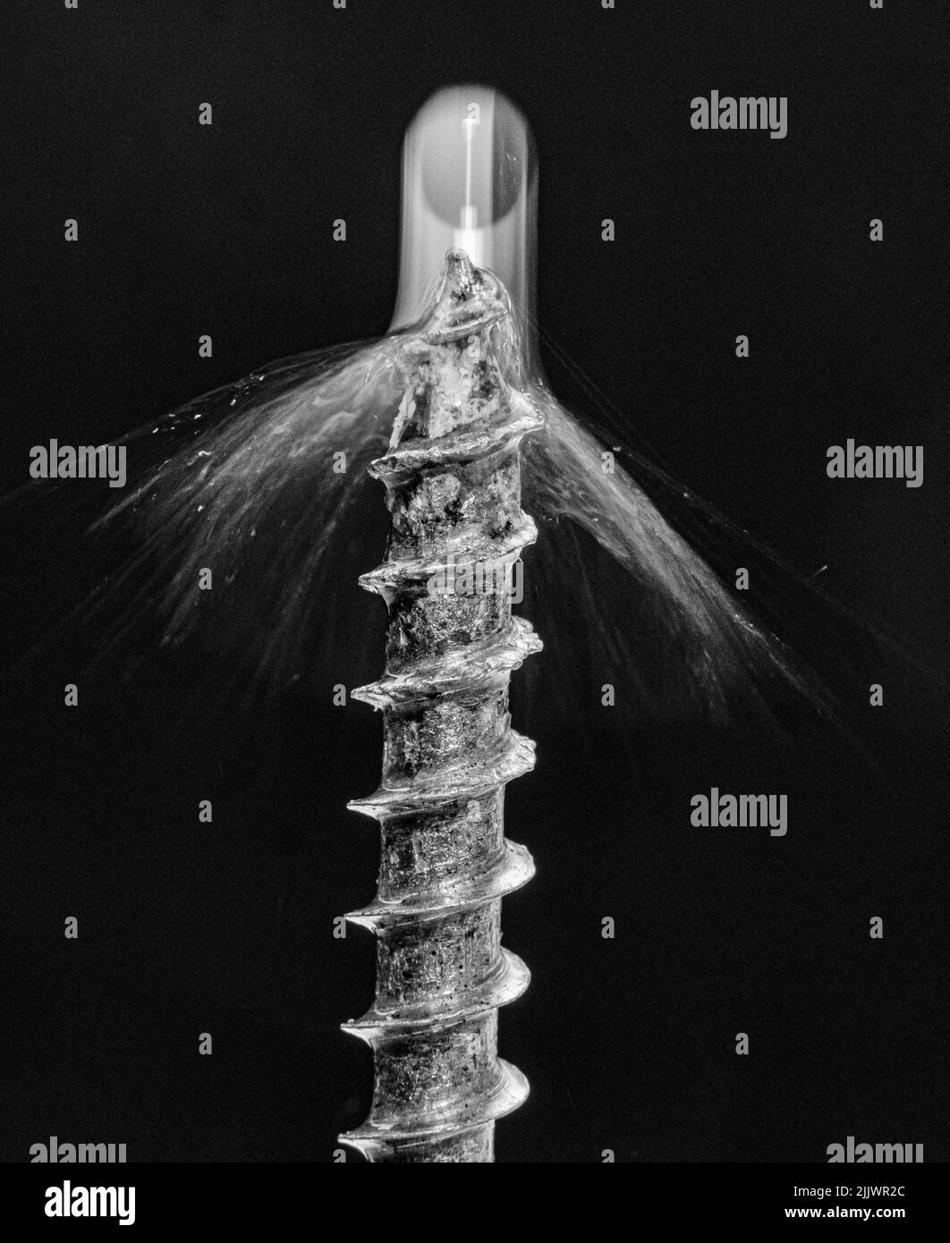 A vertical closeup shot of water dripping on a screw Stock Photo - Alamy