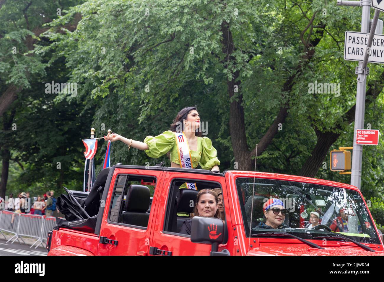 A young girl in a car with her friends celebrating the Puerto Rican Day ...
