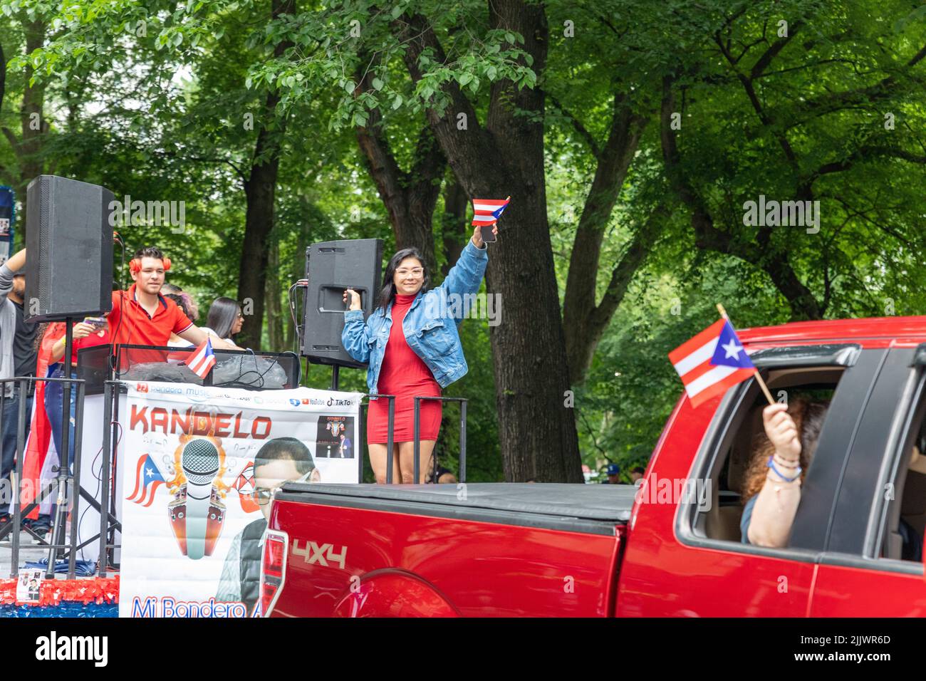 A young girl in a red dress celebrating the Puerto Rican Day Parade in ...