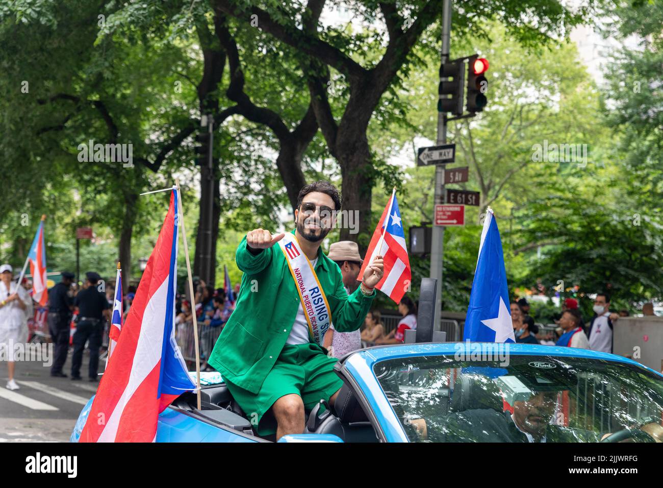 A young guy in a car with his friends celebrating the Puerto Rican Day ...