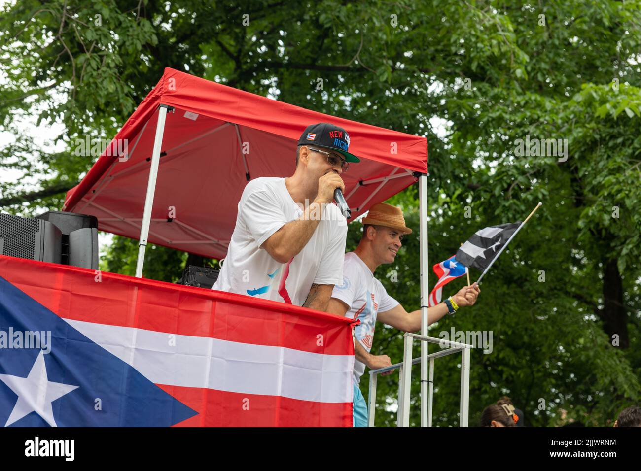 A young guy talking on a microphone and celebrating the Puerto Rican ...