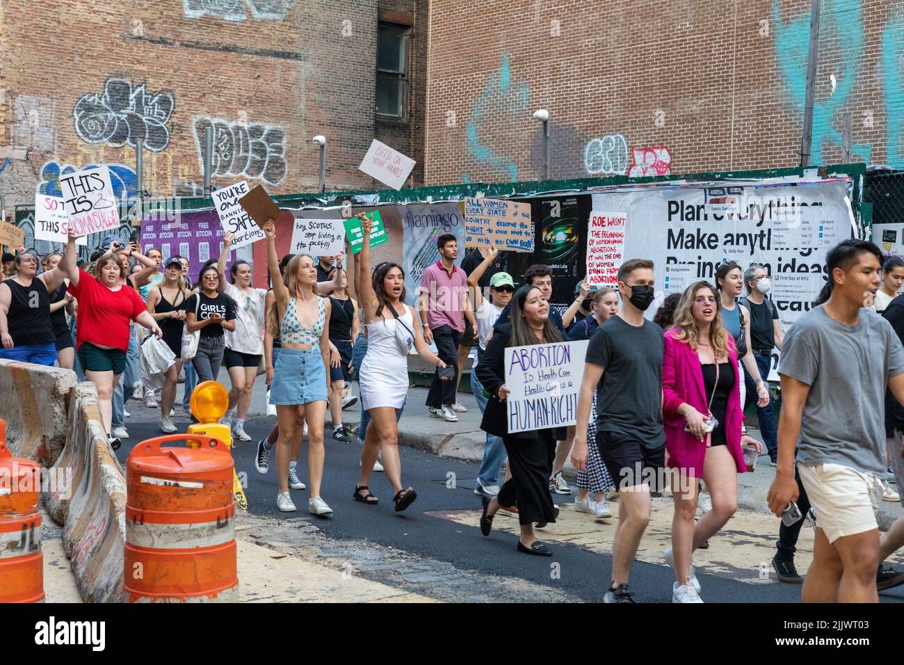 A group of protesters with cardboard signs walking to Foley Square, New ...