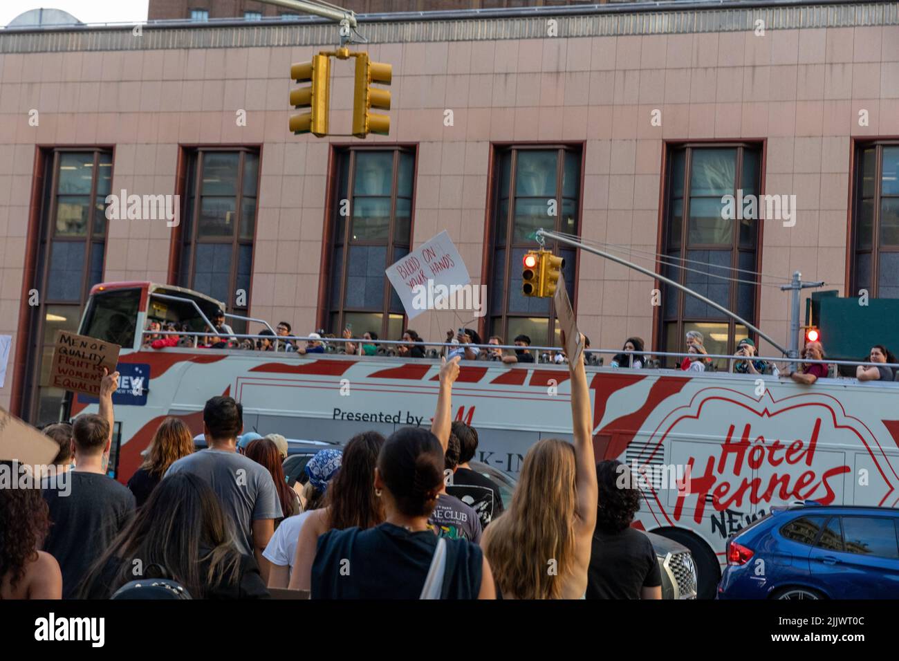 A group of protesters with cardboard signs walking to Foley Square, New ...