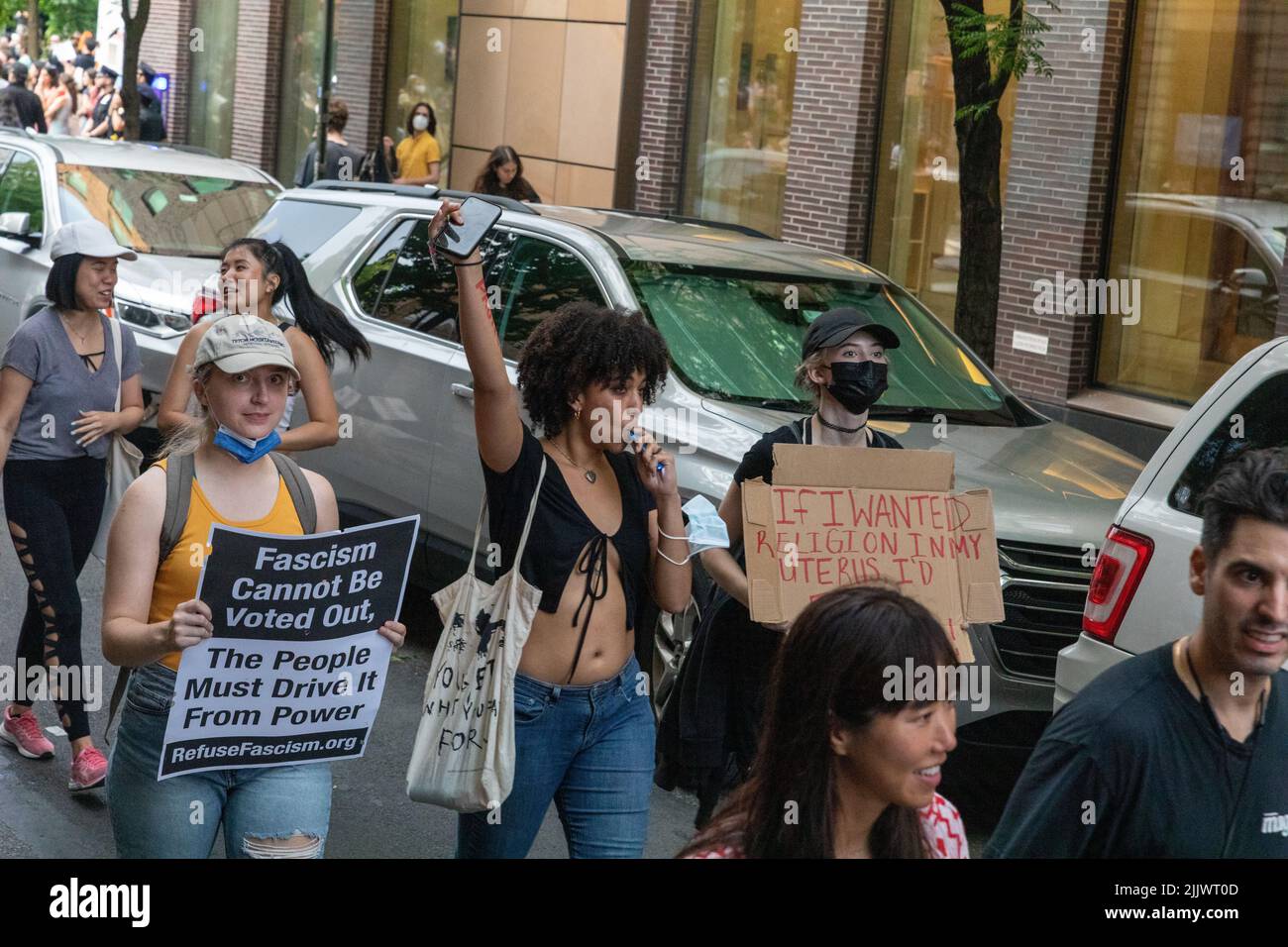 A group of protesters with cardboard signs walking to Foley Square, New ...