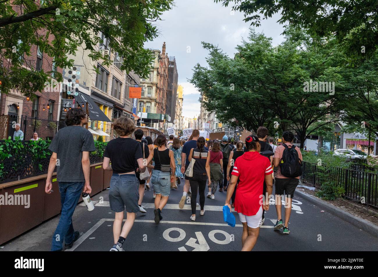 A group of protesters with cardboard signs walking to Foley Square, New ...