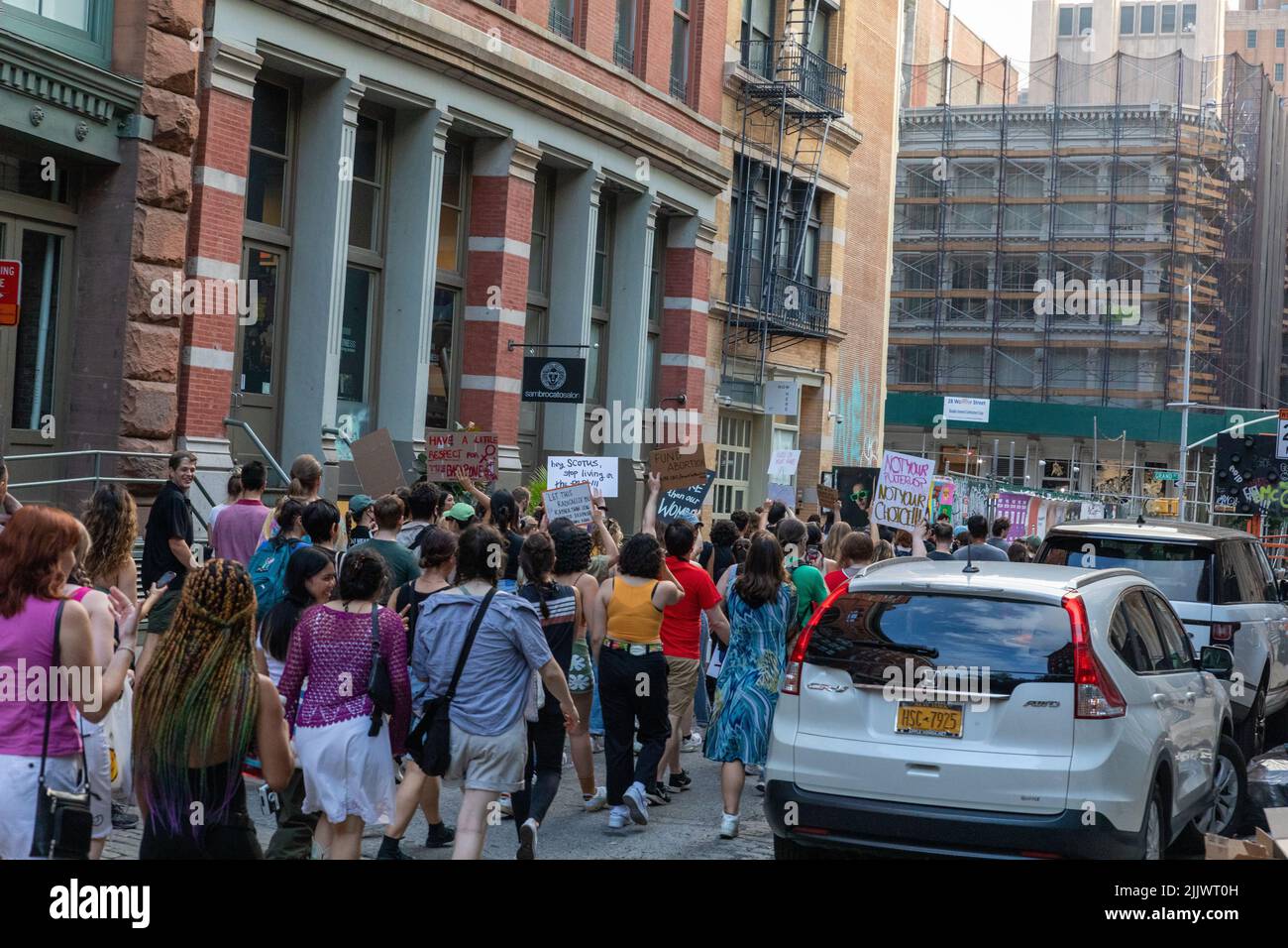 A group of protesters with cardboard signs walking to Foley Square, New ...