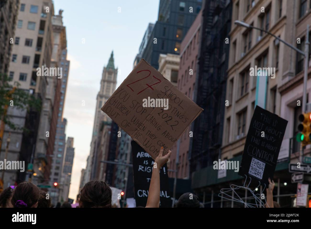 A group of protesters with cardboard signs walking to Foley Square, New ...