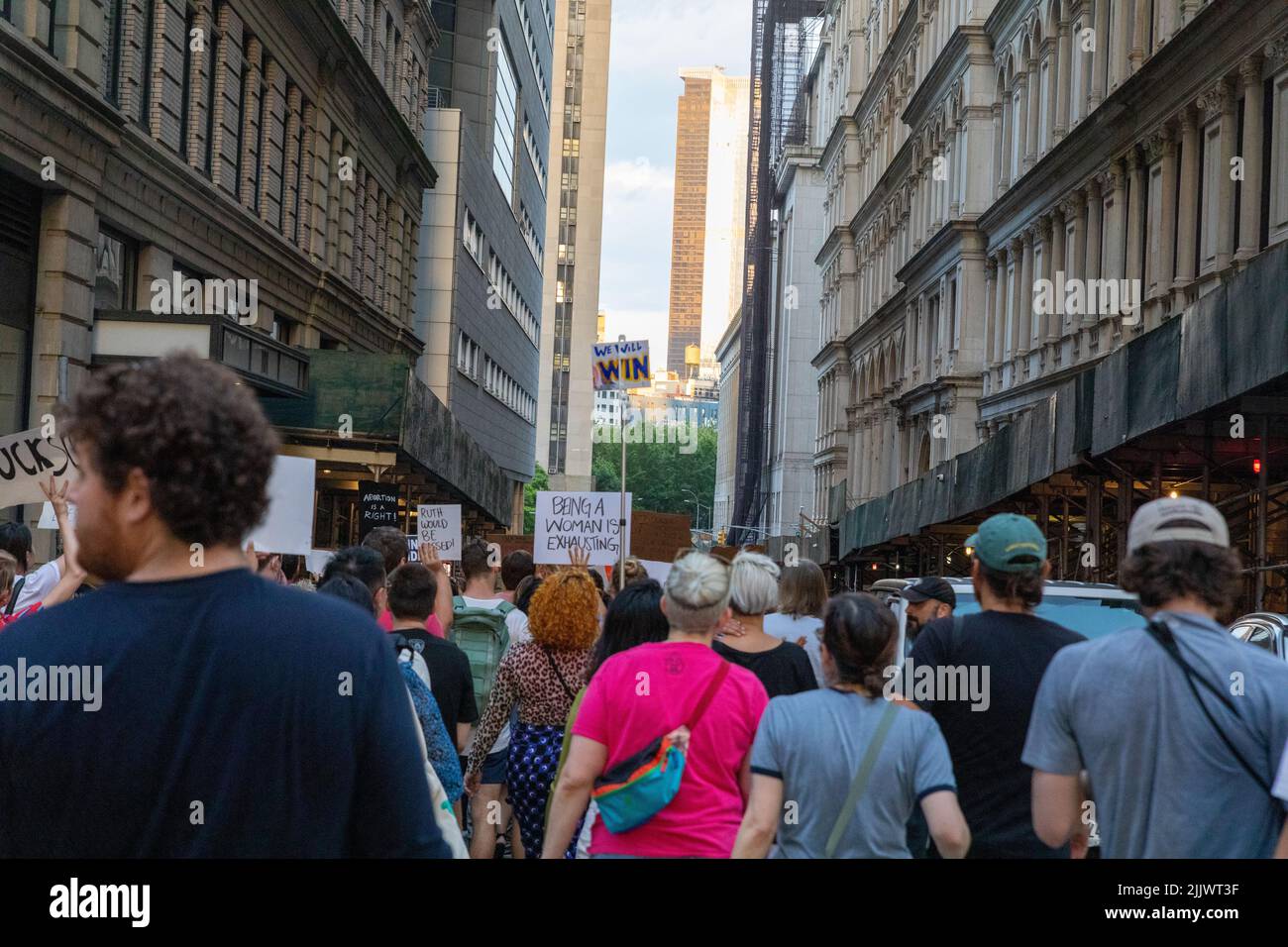 A group of protesters with cardboard signs walking to Foley Square, New ...