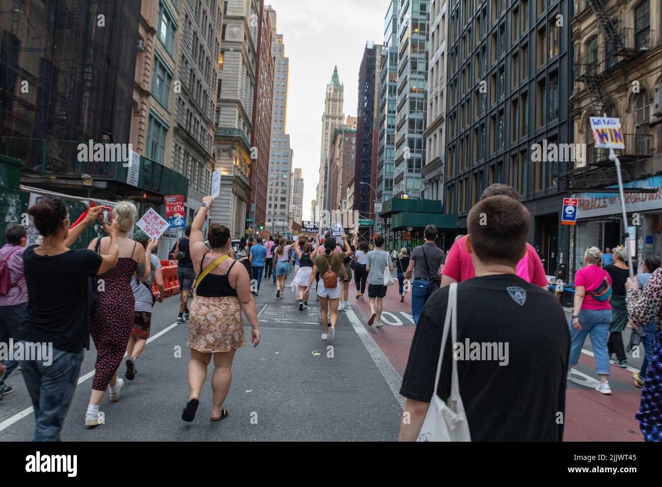 A group of protesters with cardboard signs walking to Foley Square, New ...