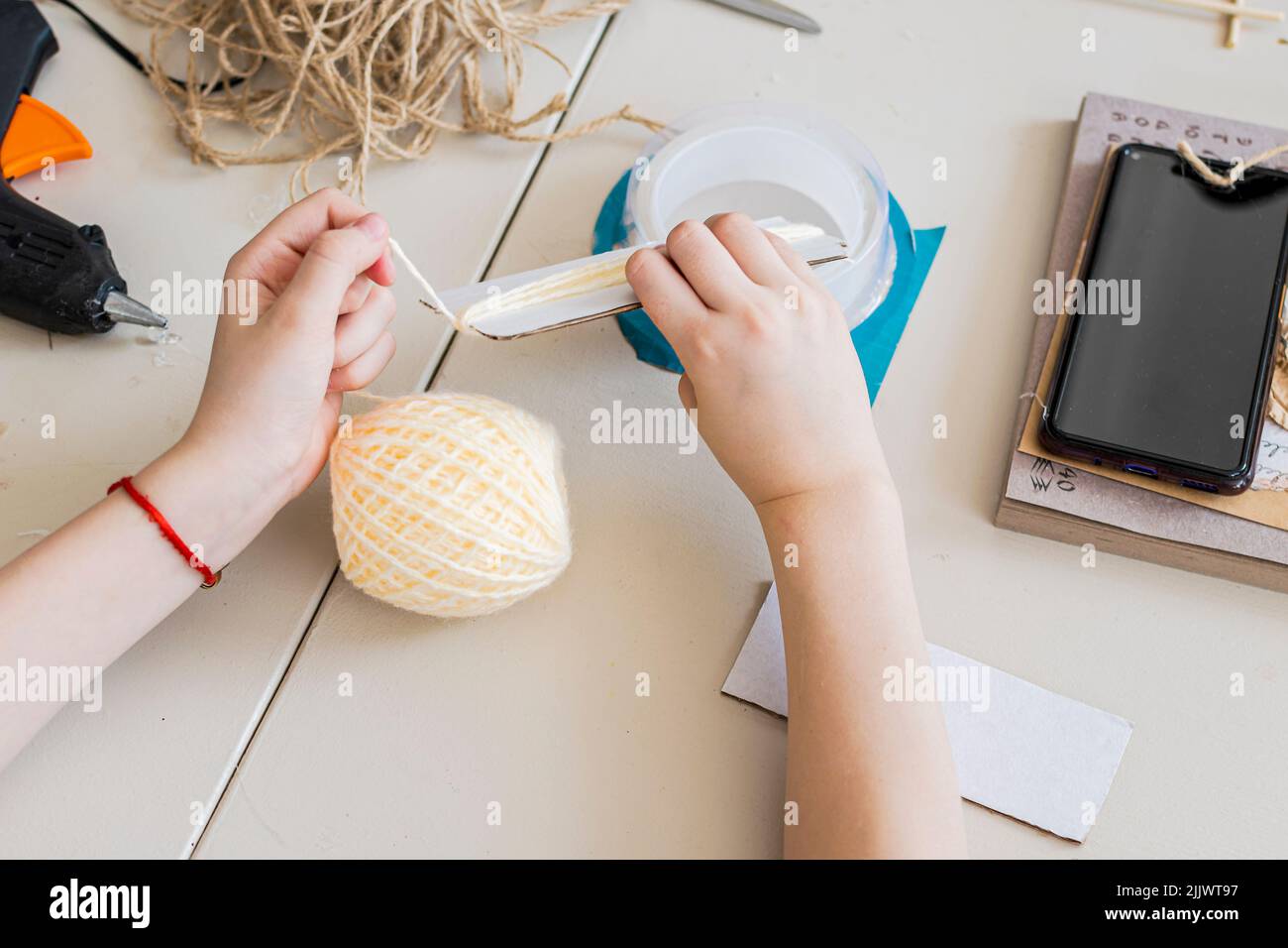 Adult hands wind ball thread hi-res stock photography and images - Alamy