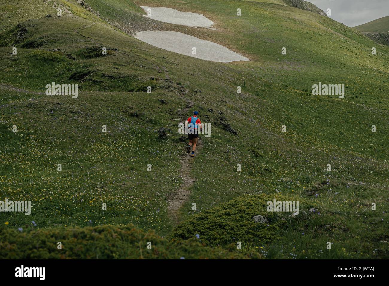 male runner running on mountain trail marathon Stock Photo - Alamy