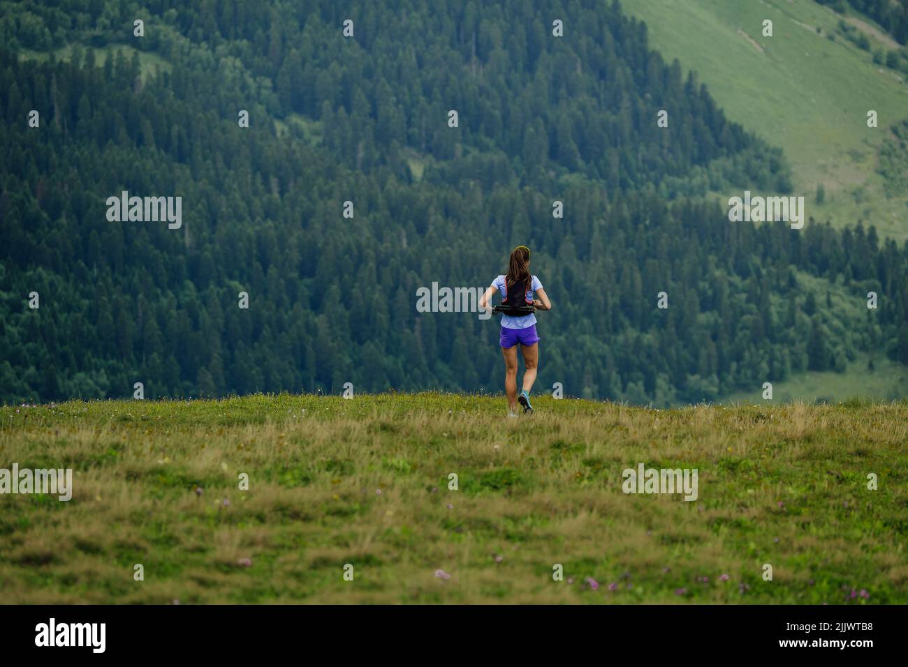 female trail runner running ultramarathon race Stock Photo - Alamy
