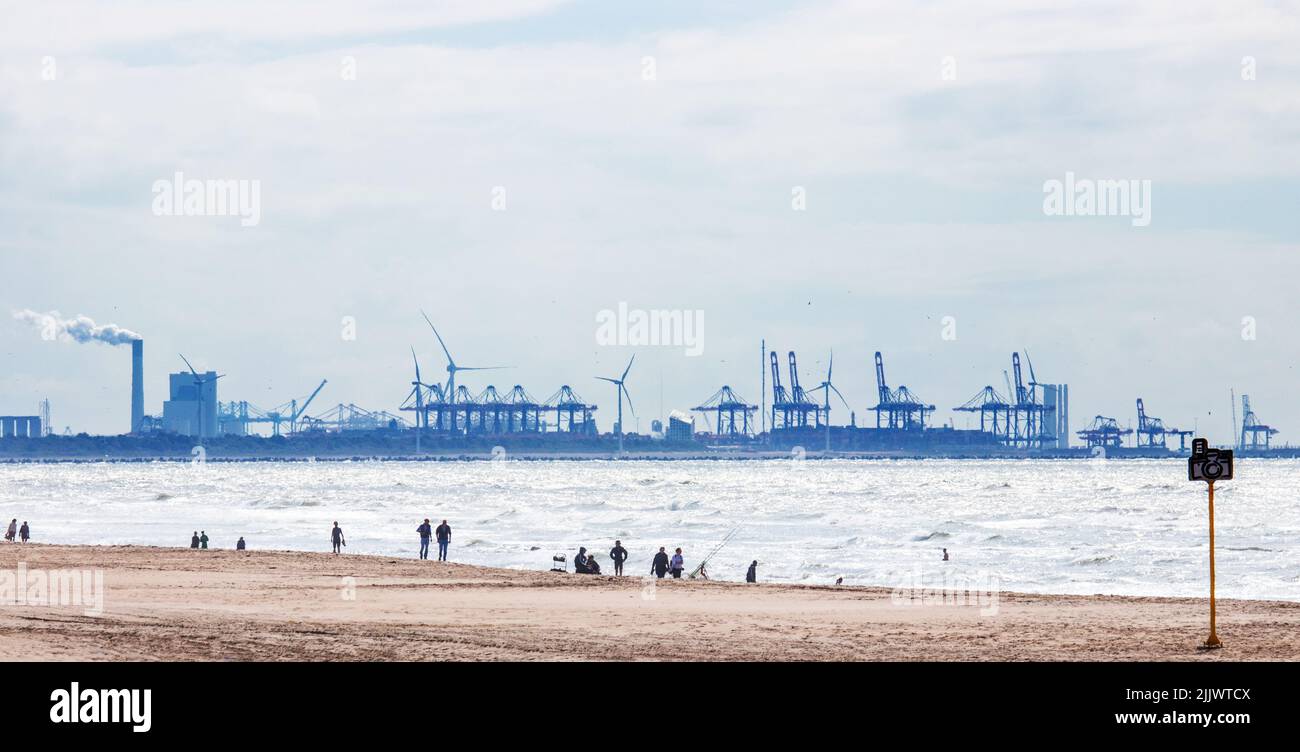 People strolling on the Dutch beach against the background of the ...
