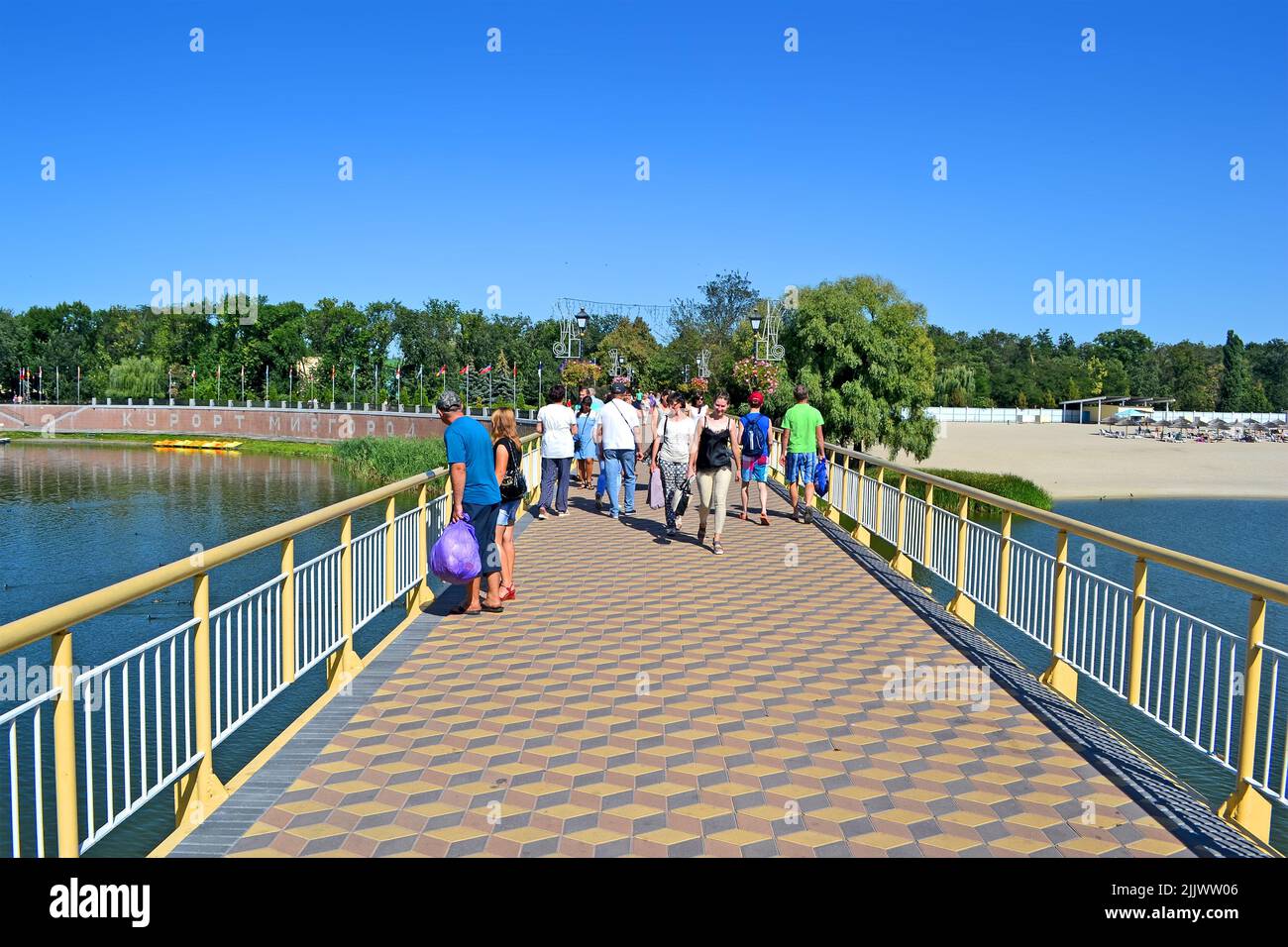 Ukrainian wellness resort Myrhorod, people on the pedestrian bridge in ...