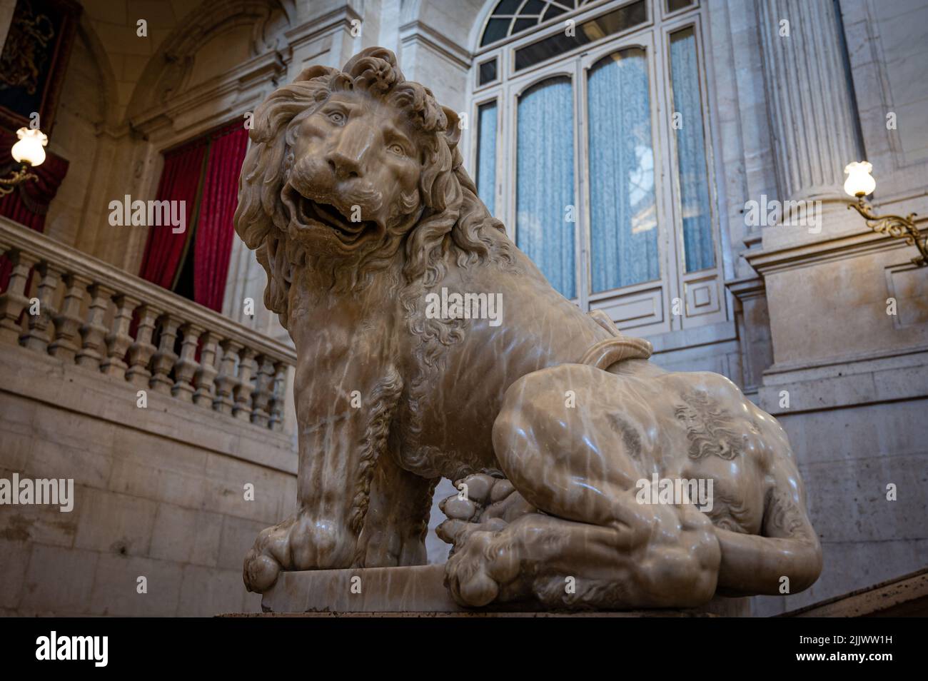 A sculpture of a male lion inside the luxurious Royal Palace of Madrid ...