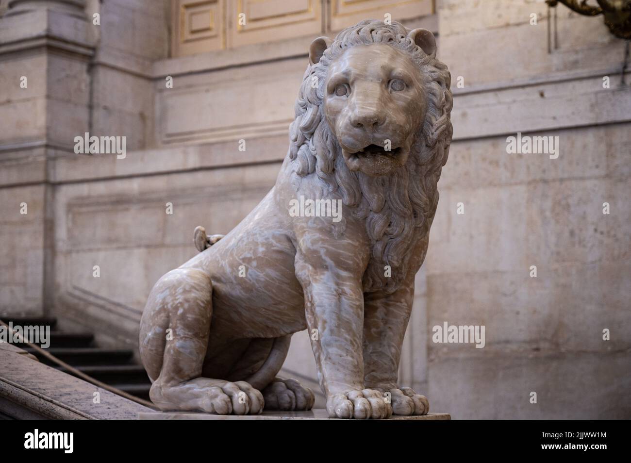 A sculpture of a male lion inside the luxurious Royal Palace of Madrid ...