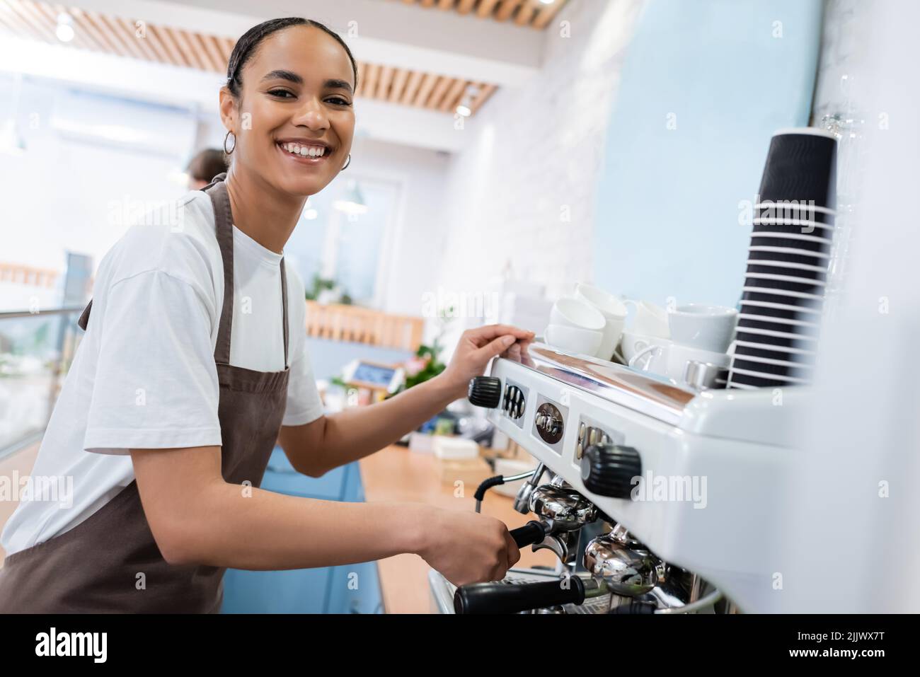 Cheerful african woman barista making hi-res stock photography and ...