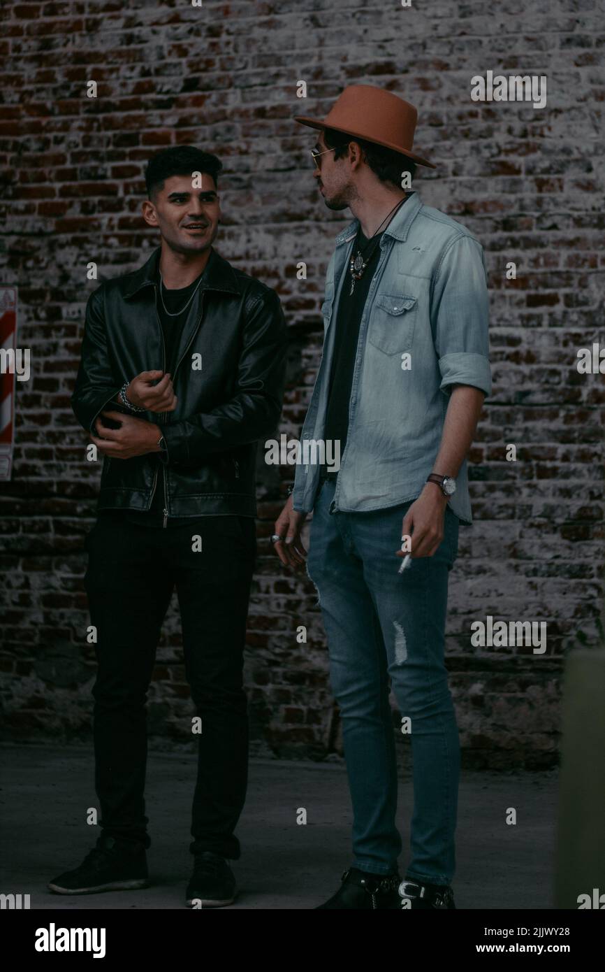 Two male friends talking rock hi-res stock photography and images - Alamy