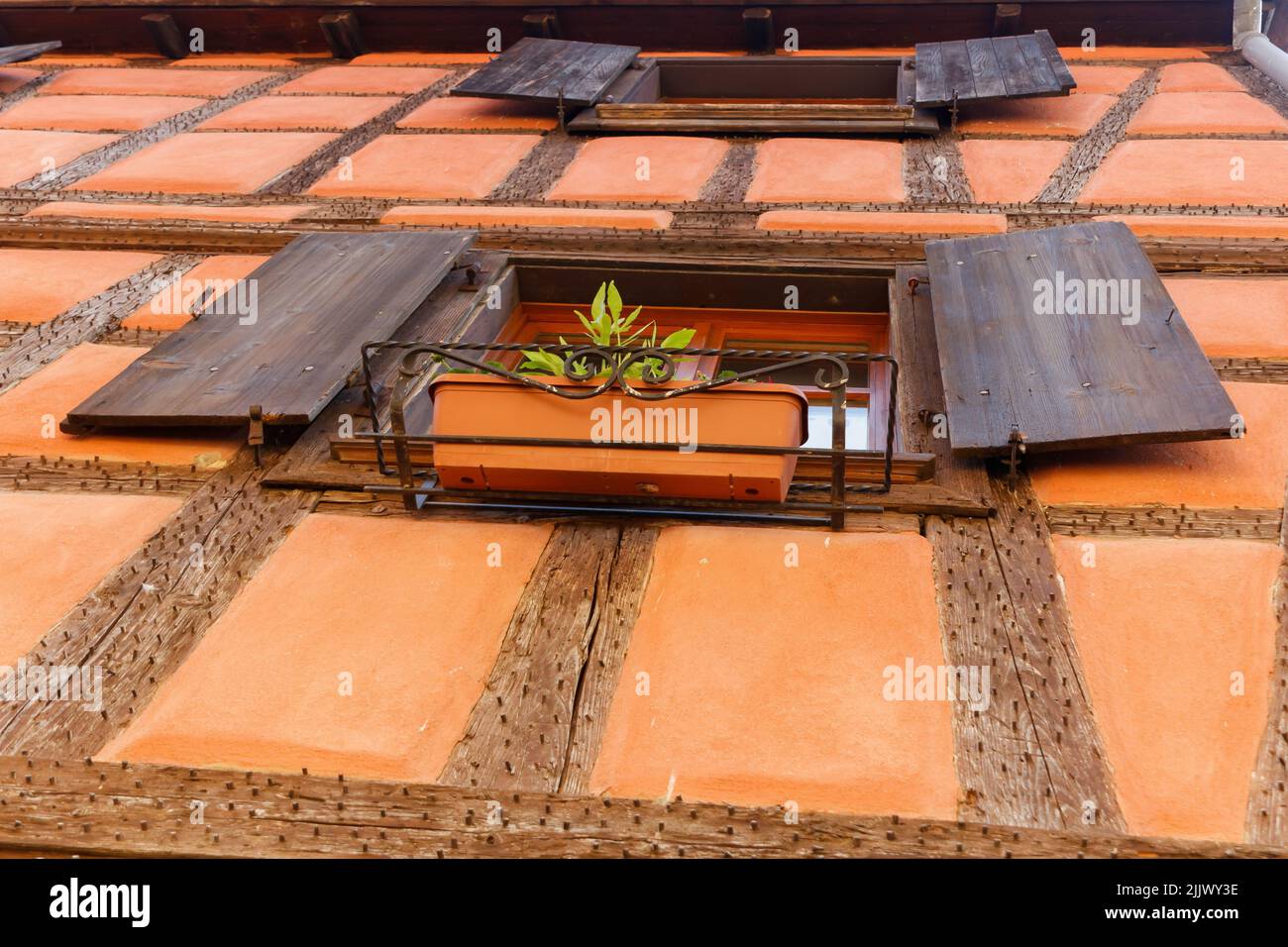 A low angle of an old window of a building on a sunny day in Eguisheim ...