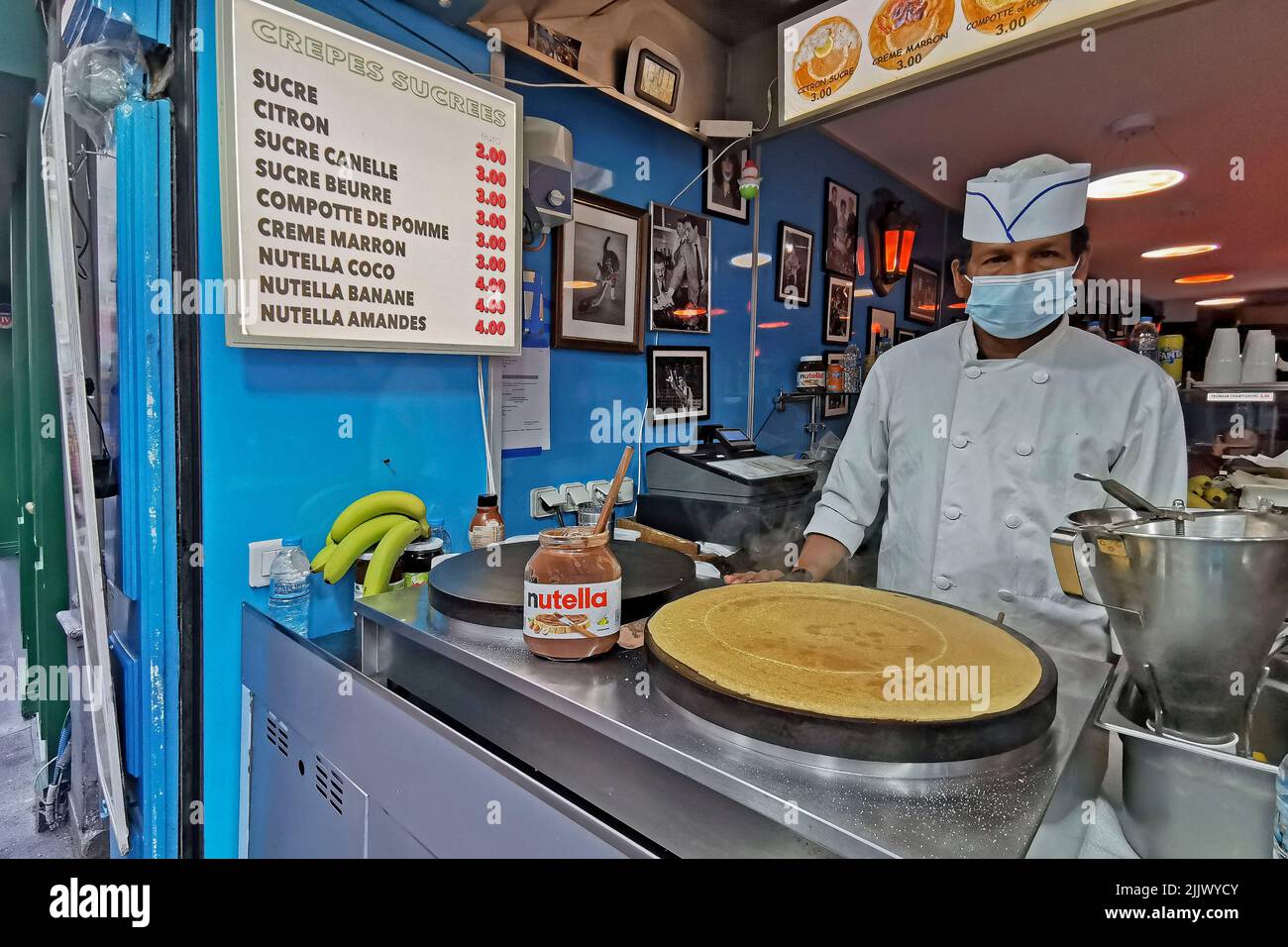 France, Paris, Man making crepes at a Creperie Photo © Fabio Mazzarella ...