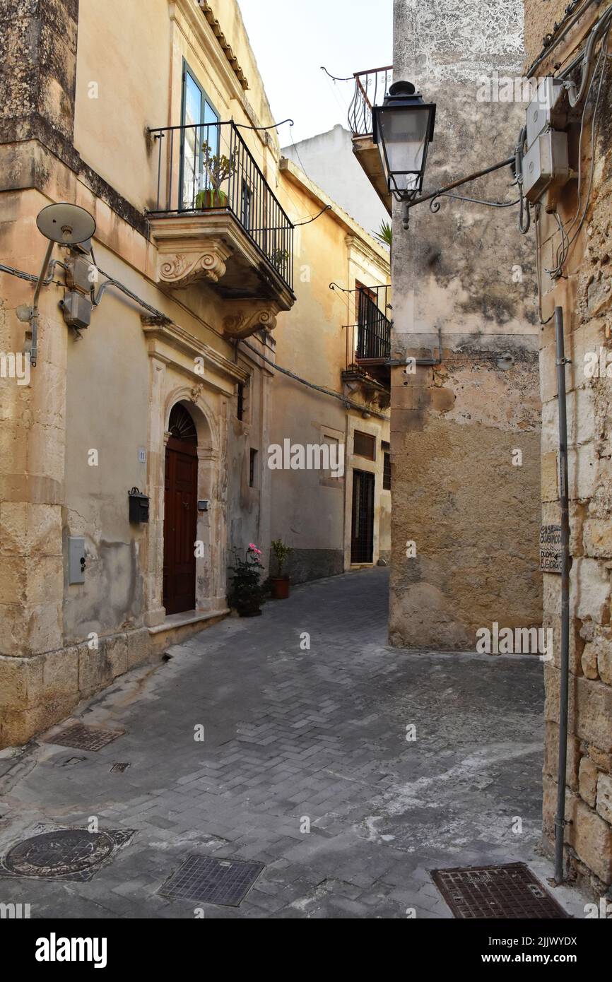 A vertical shot of a narrow alley between old buildings in the old town ...