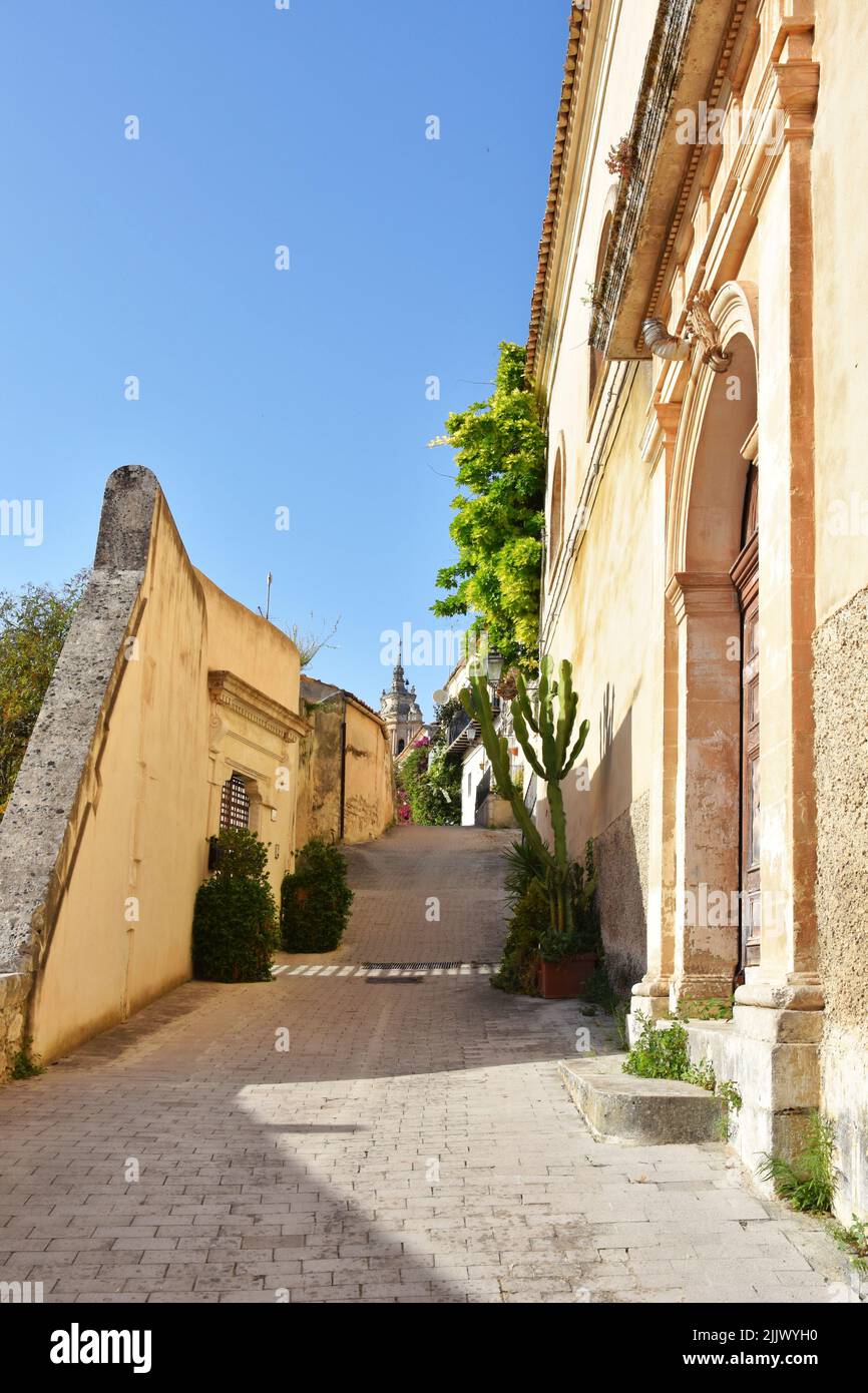 A vertical shot of a narrow alley between old buildings in the old town ...