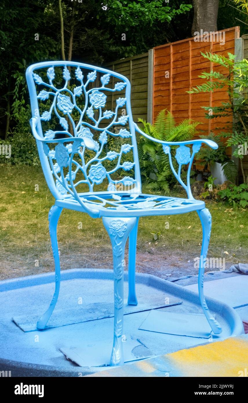 Bright blue freshly painted wrought iron garden chair, UK Stock Photo ...