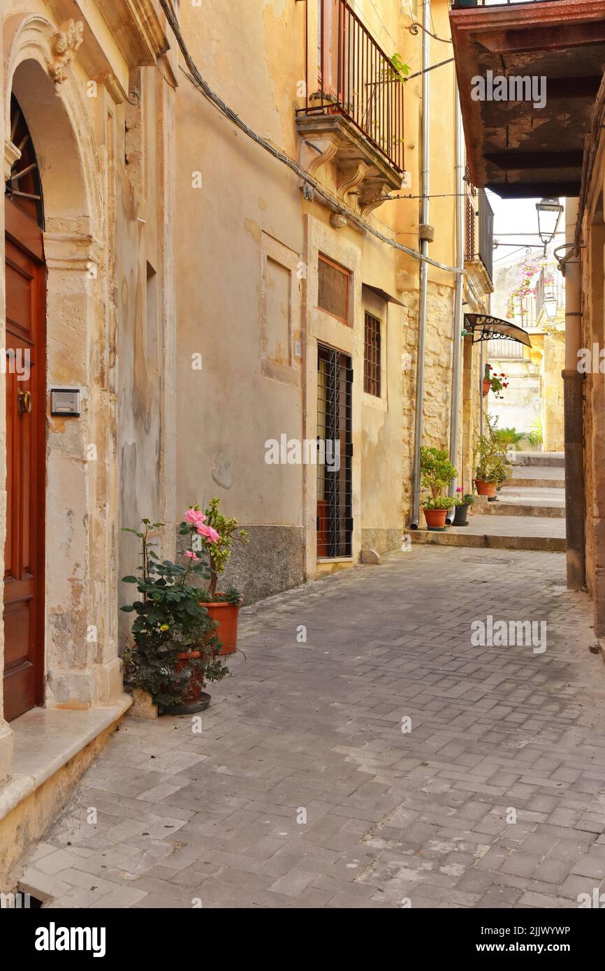 A narrow street in the old town of Modica in Sicily, Italy Stock Photo ...