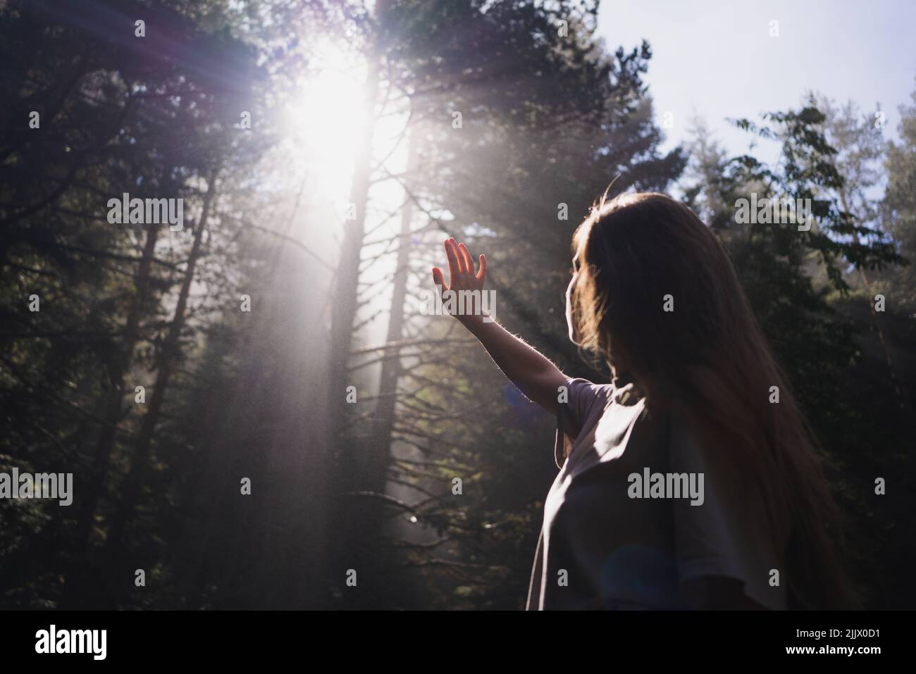 From below side view of female traveler standing with outstretch arm in ...