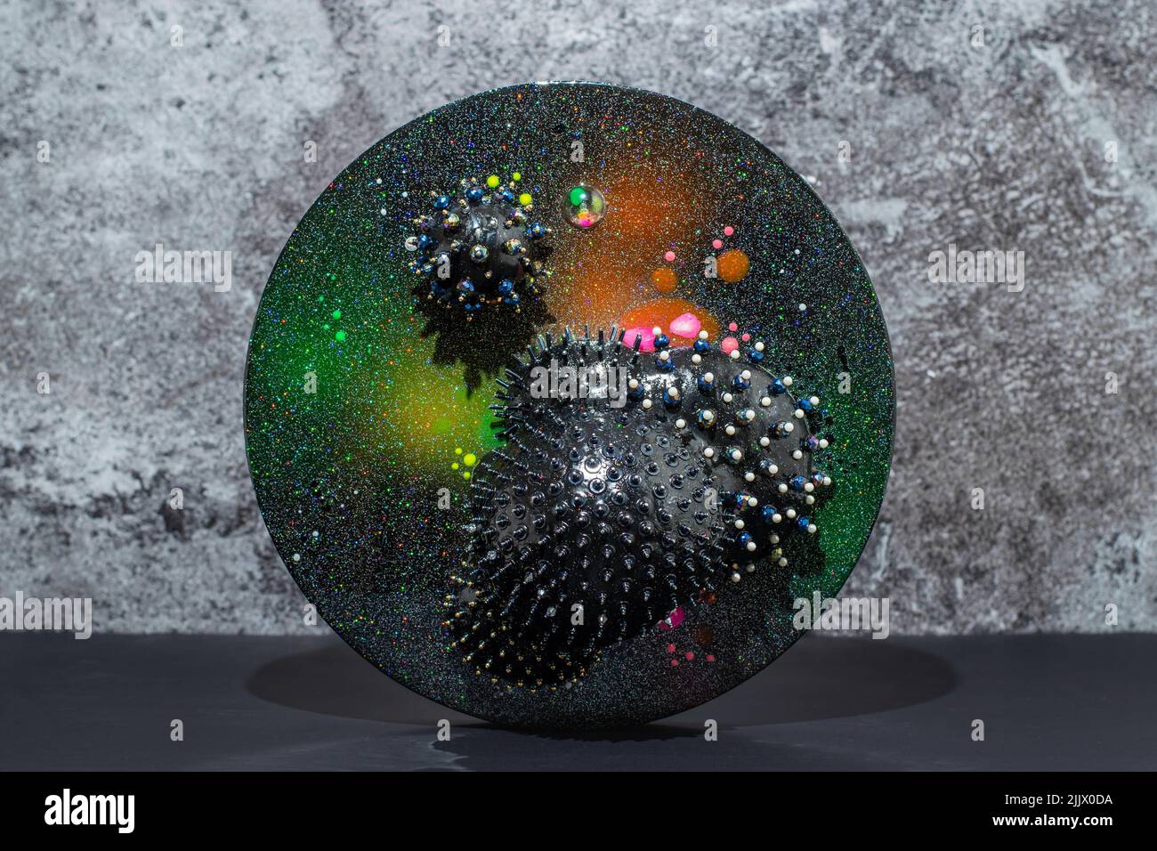 A round circle glitter blob art work of microcosmos space microbes with symmetrical dot pattern ...
