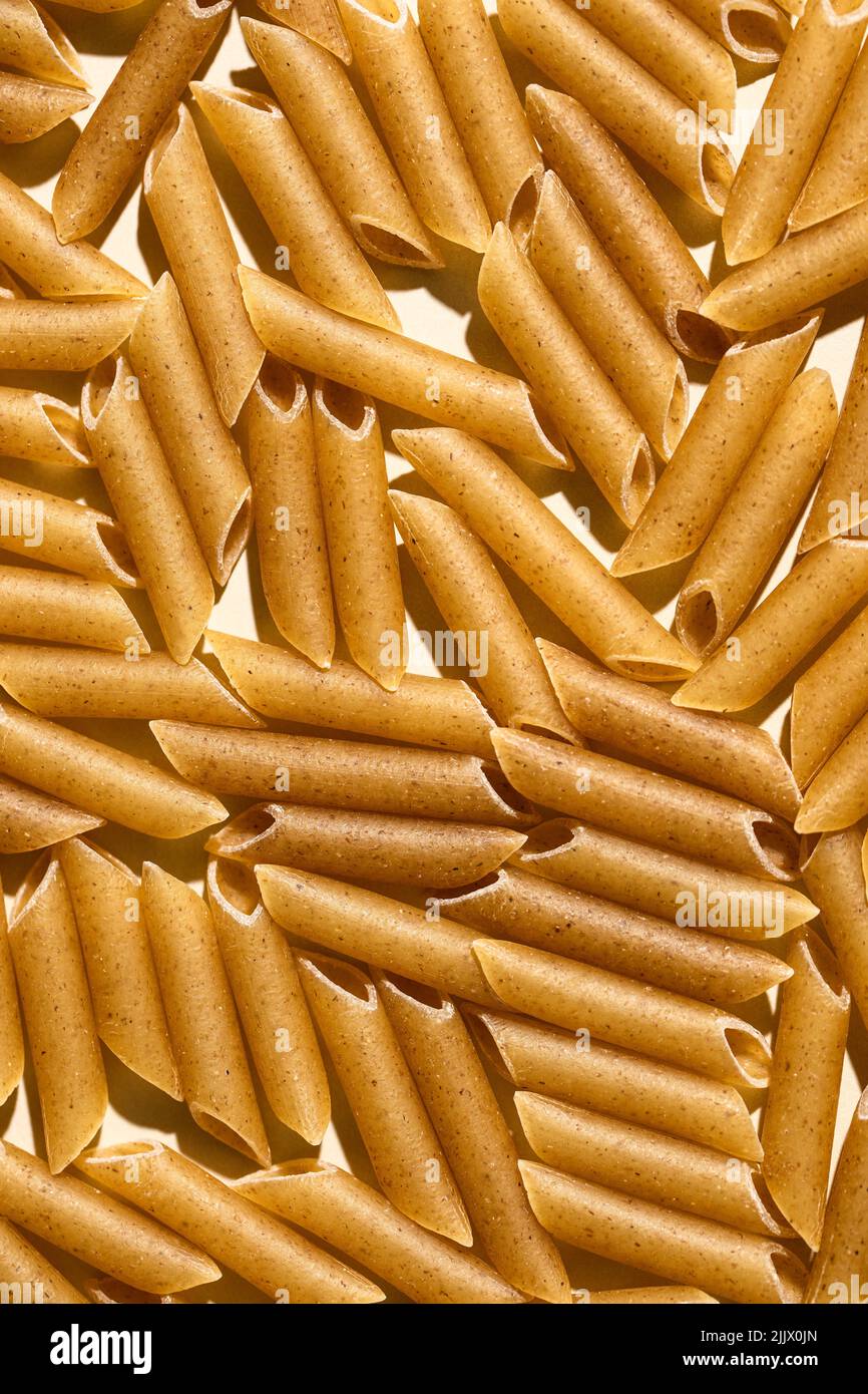 Top view of uncooked pasta arranged on white background and forming ...