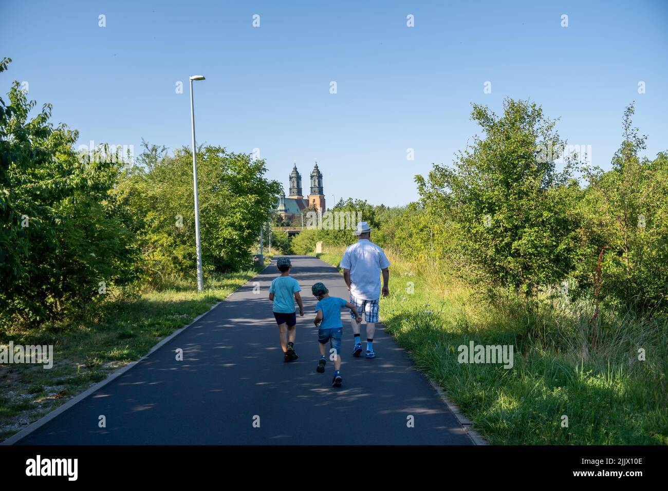A man and two kids walking on a footpath leading to the Piotr and Pawel ...