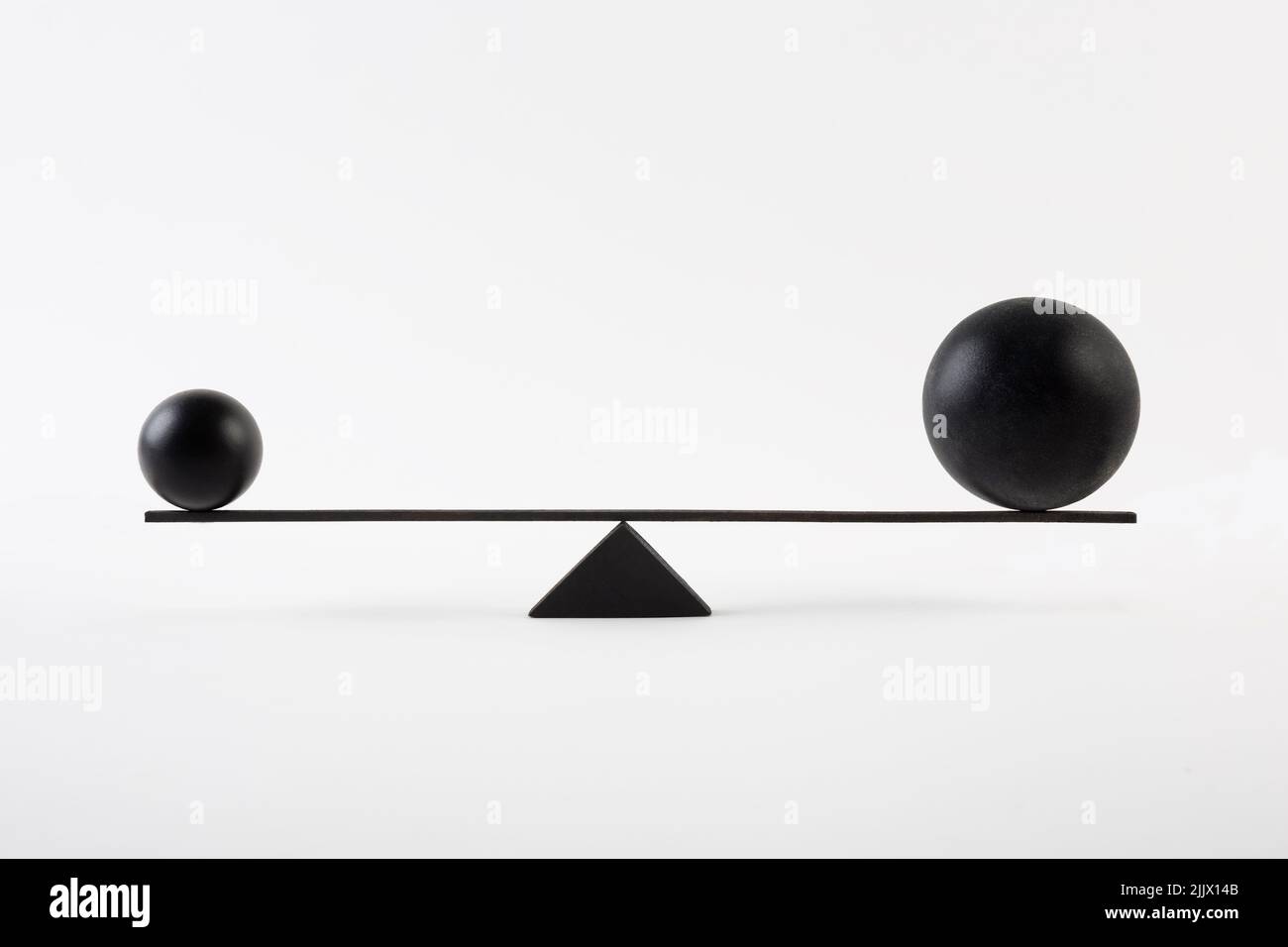 Small and big black spheres balancing on minimalist style geometric ...