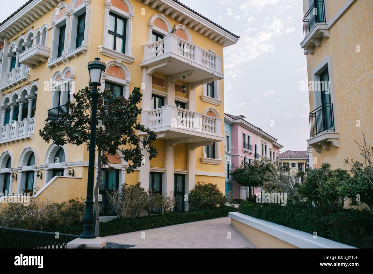 Apartment buildings with ornamental windows and balconies located near ...