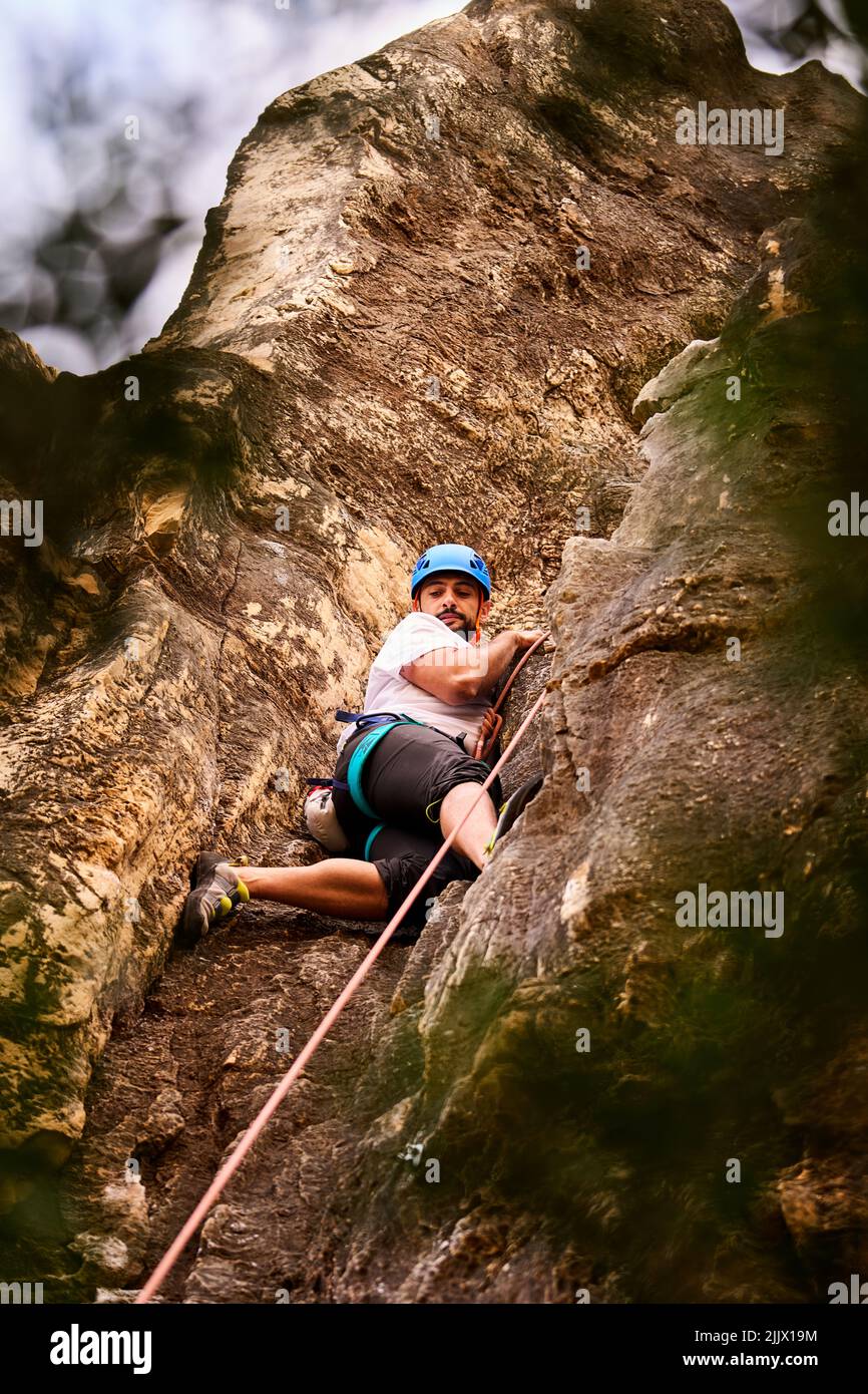 Man climbing on rocky hi-res stock photography and images - Alamy