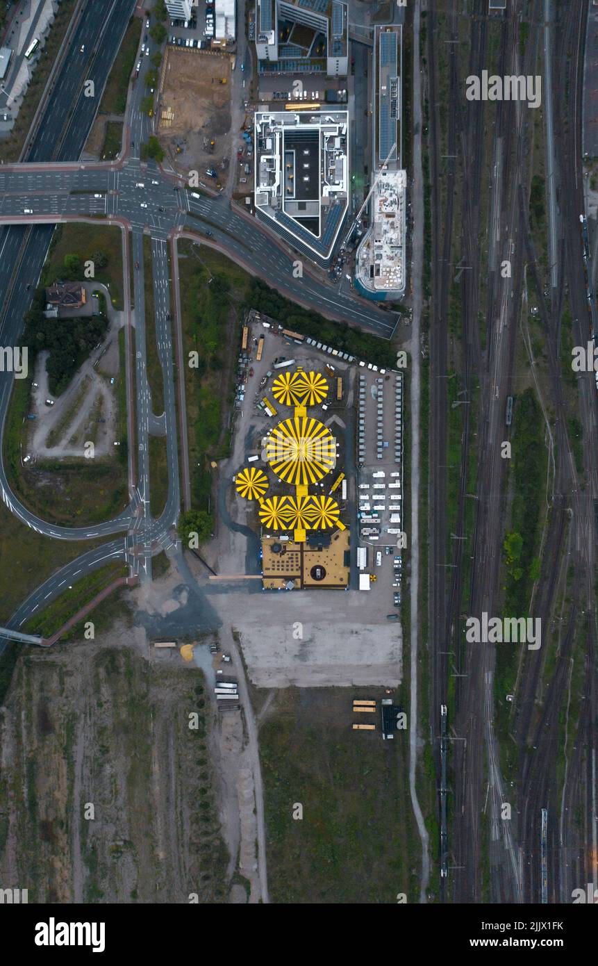 Aerial view of fun fair near along asphalt road between in modern city ...