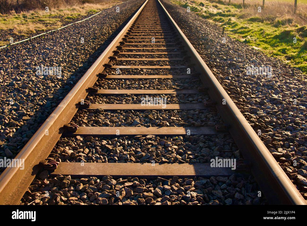An empty railroad track under the sunlight - perfect for backgrounds ...