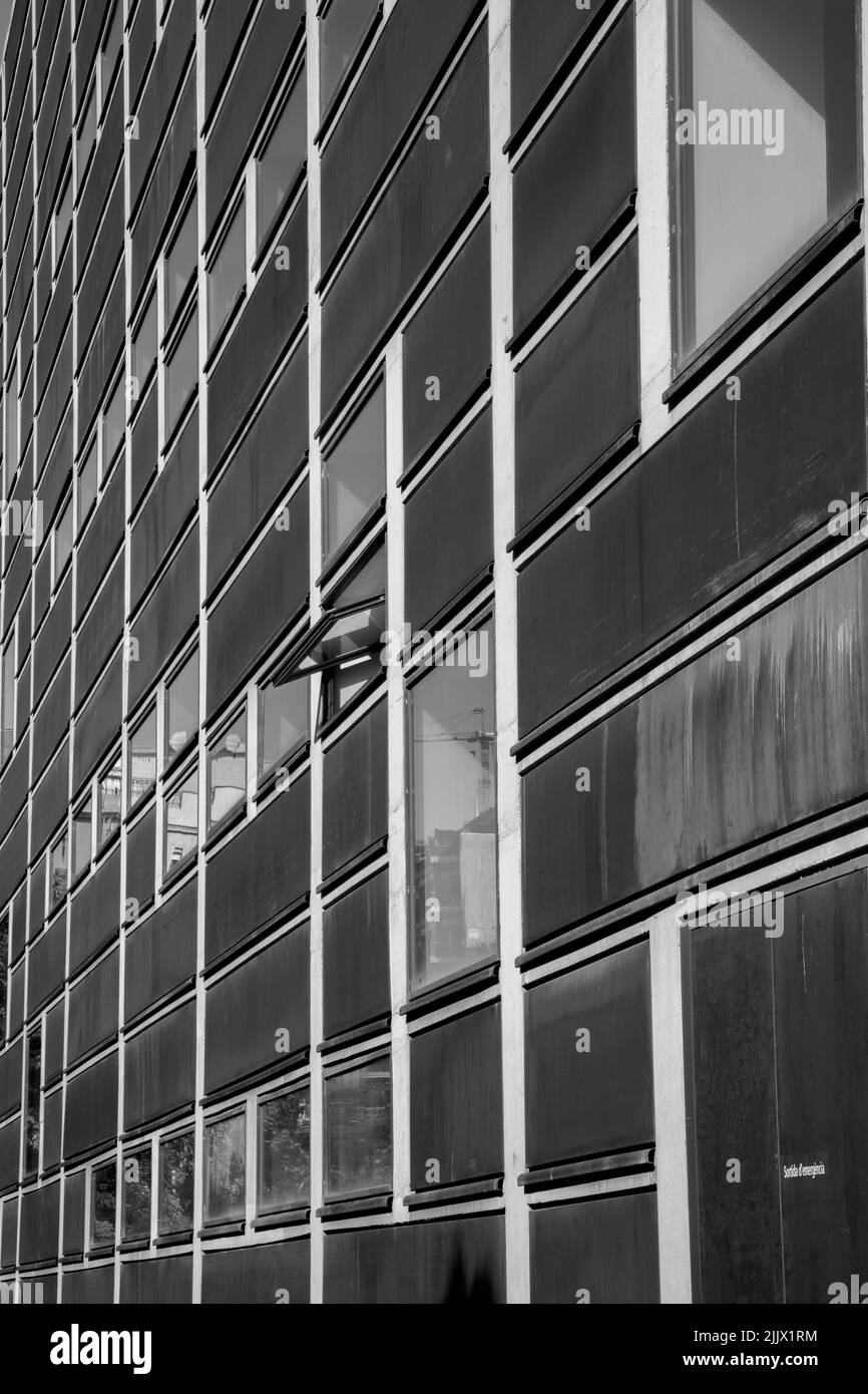 A greyscale vertical shot of a window facade grid Stock Photo - Alamy